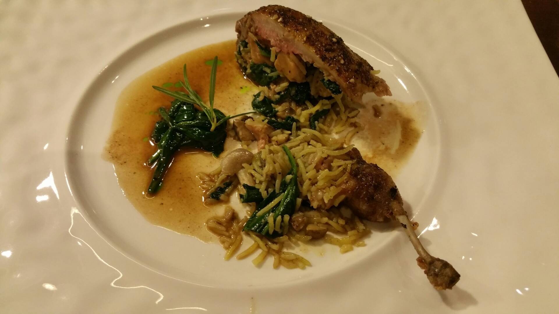 Roasted stuffed French quail with foie gras, wild mushroom, wild rice ...